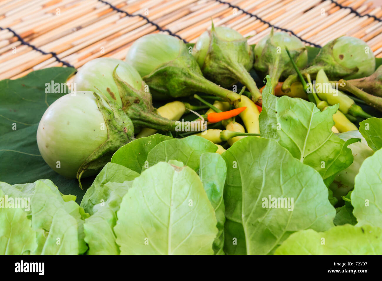 true vegetable on leaf and bamboo blind floor Stock Photo - Alamy
