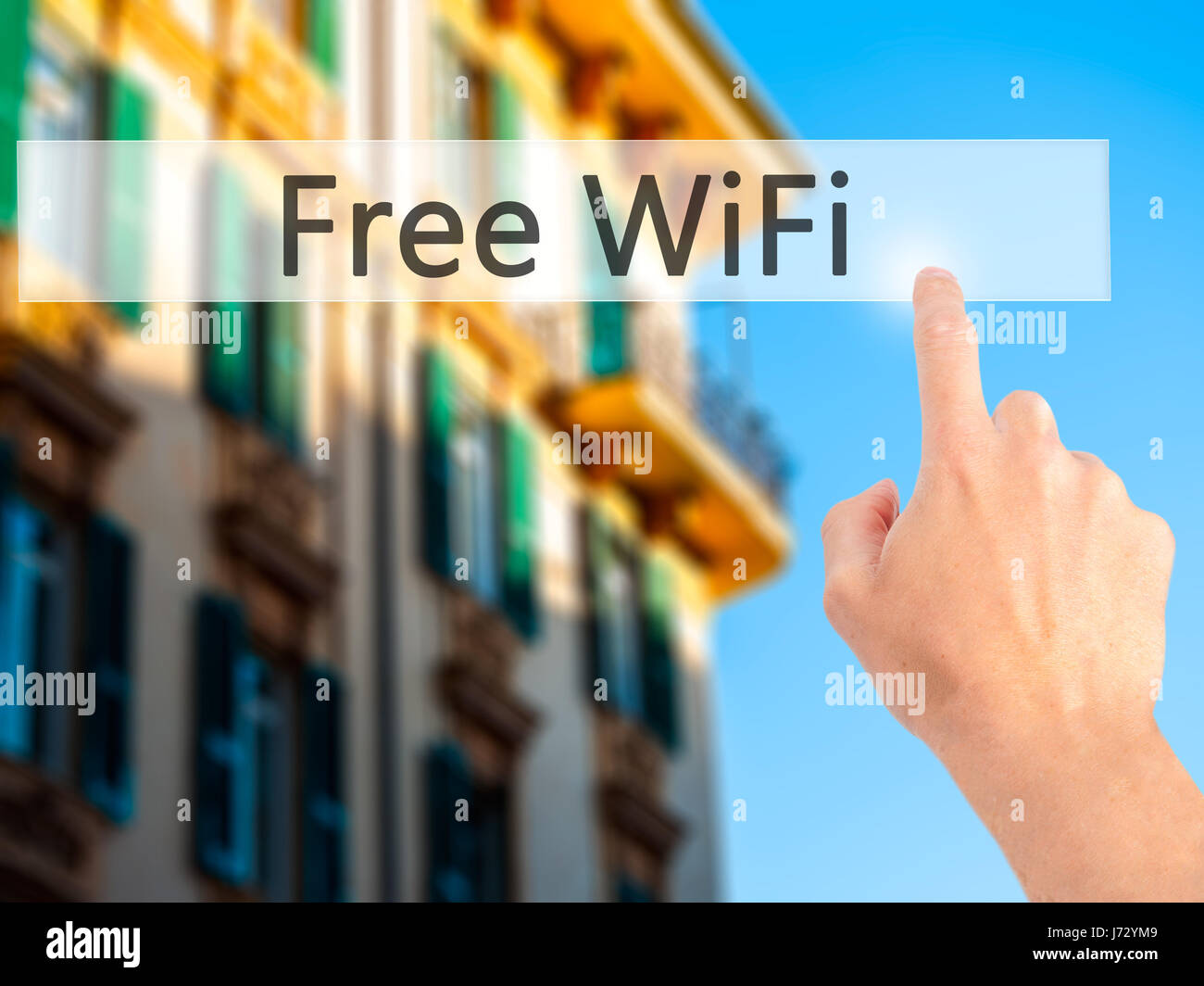 Free WiFi - Hand pressing a button on blurred background concept ...