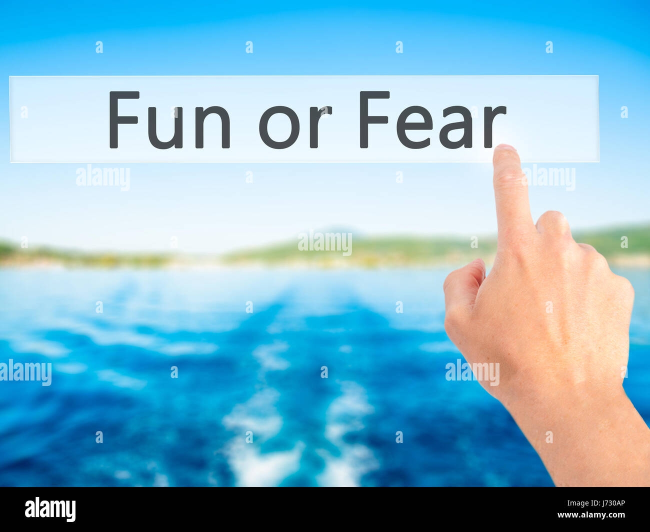 Fun or Fear - Hand pressing a button on blurred background concept ...