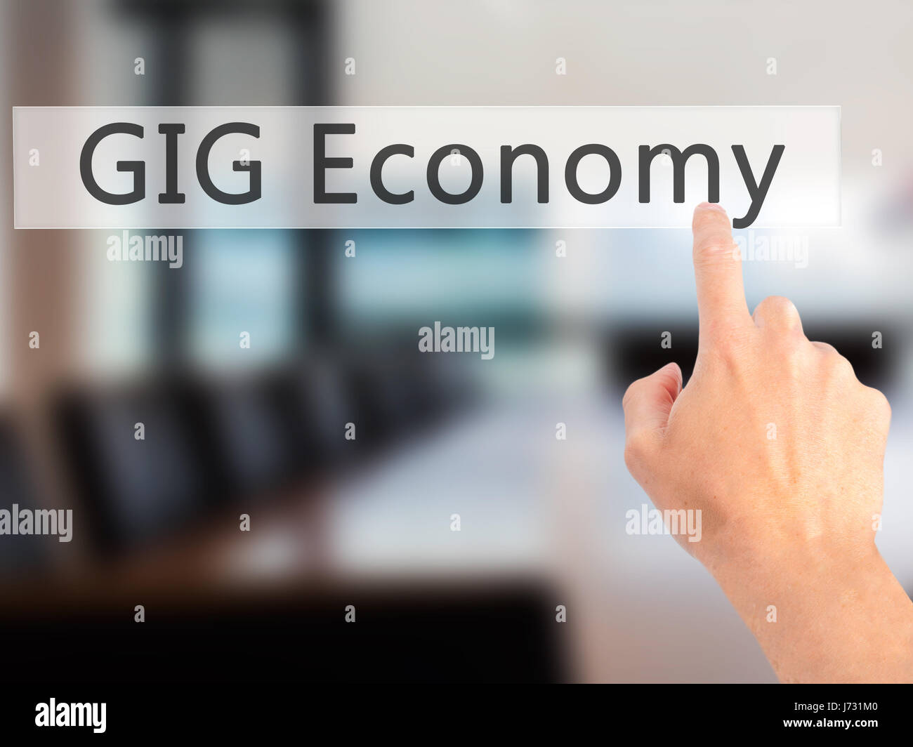 GIG Economy - Hand pressing a button on blurred background concept ...