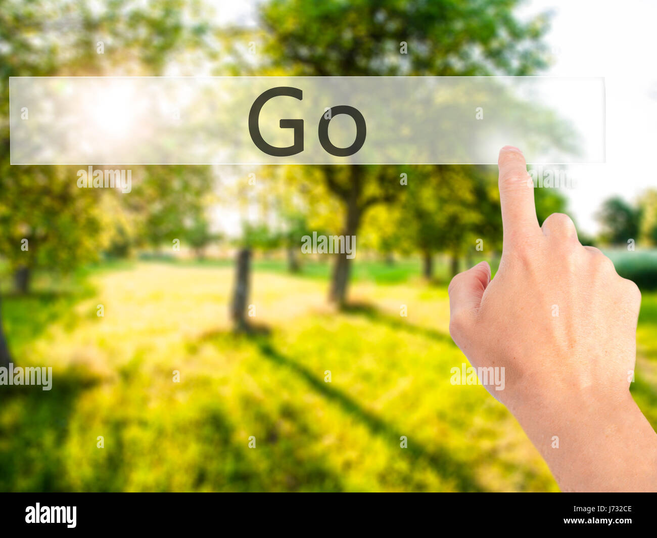 Go - Hand pressing a button on blurred background concept . Business ...