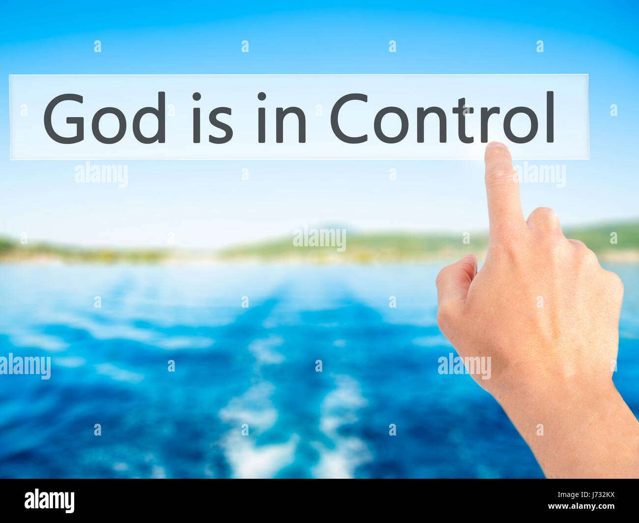God is in Control - Hand pressing a button on blurred background ...