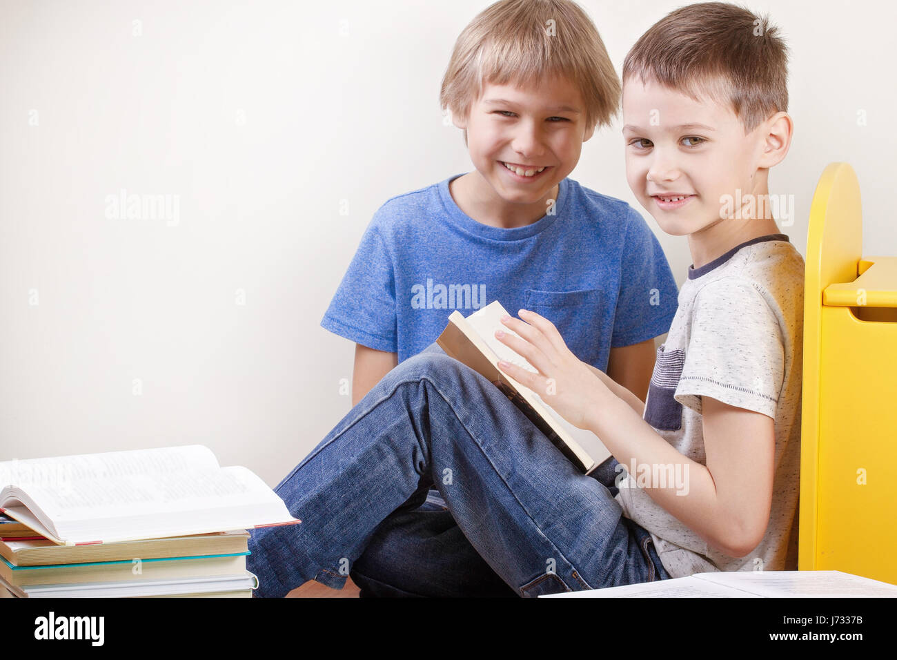 Kids reading books at home Stock Photo - Alamy