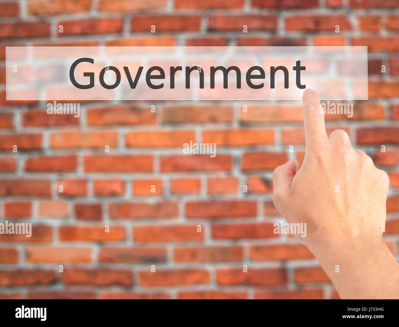 Government - Hand pressing a button on blurred background concept ...