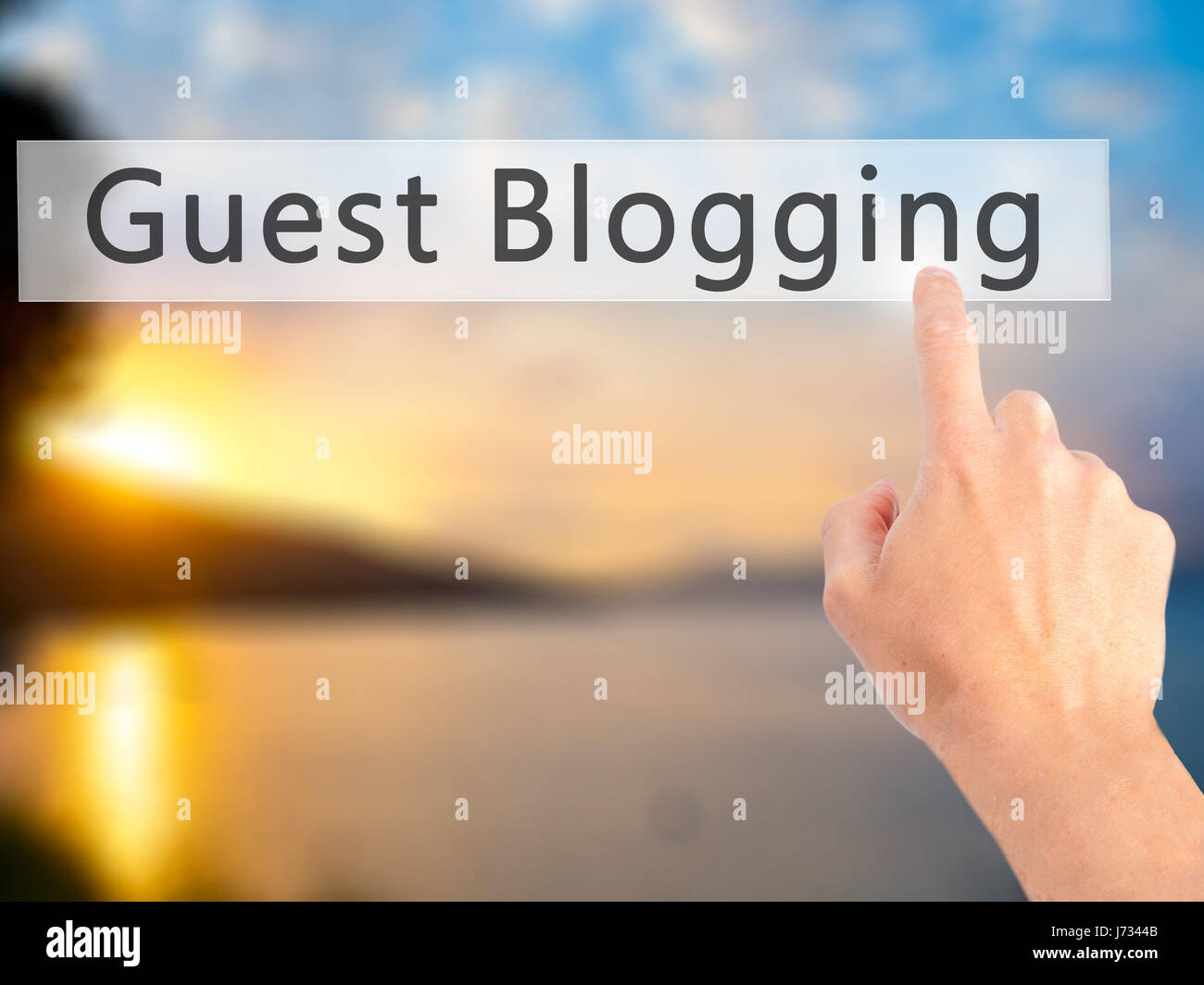 Guest Blogging - Hand pressing a button on blurred background concept ...