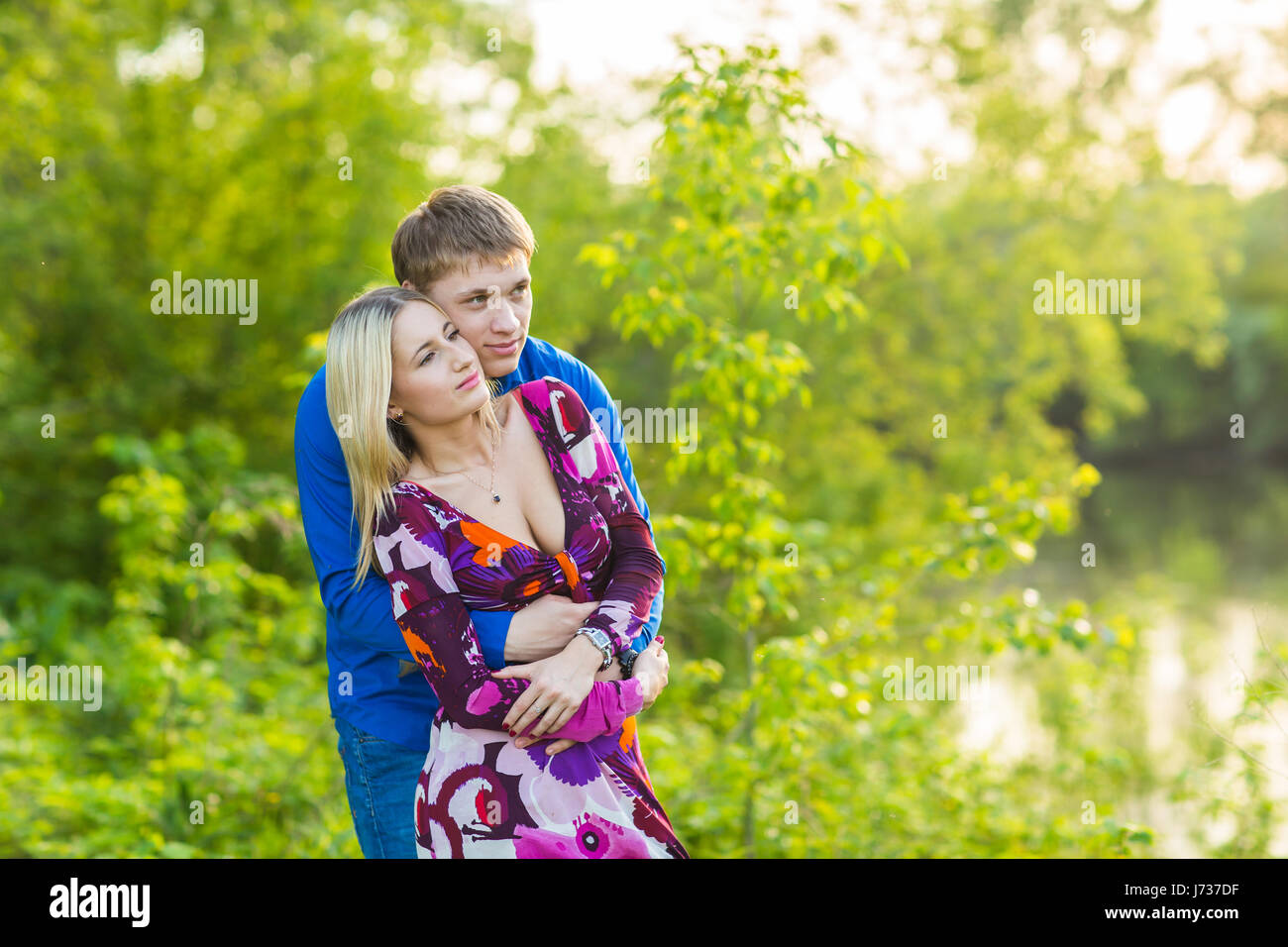 beautiful young couple hugging in the park Stock Photo - Alamy