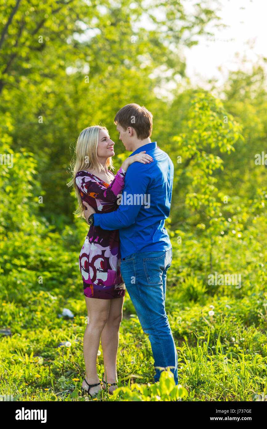 beautiful young couple hugging in the park Stock Photo - Alamy
