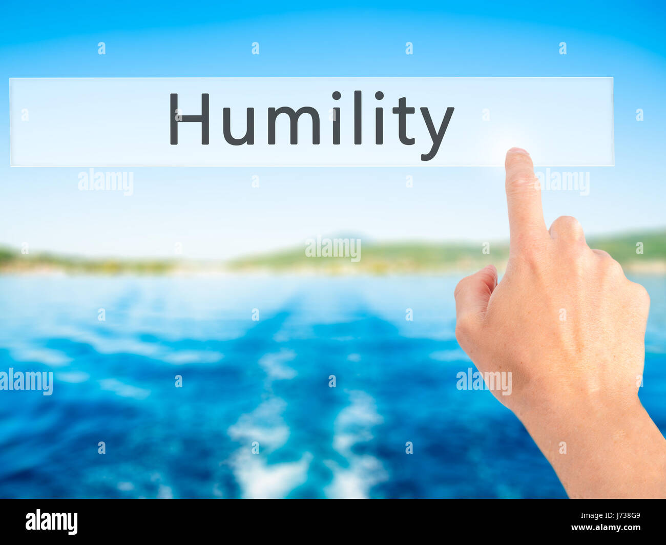 Humility - Hand pressing a button on blurred background concept ...