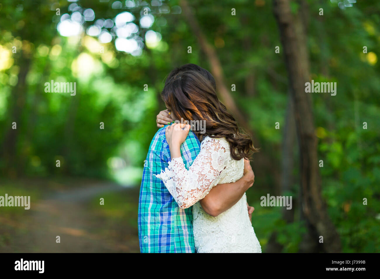 Portrait of a young romantic couple embracing each other on nature ...