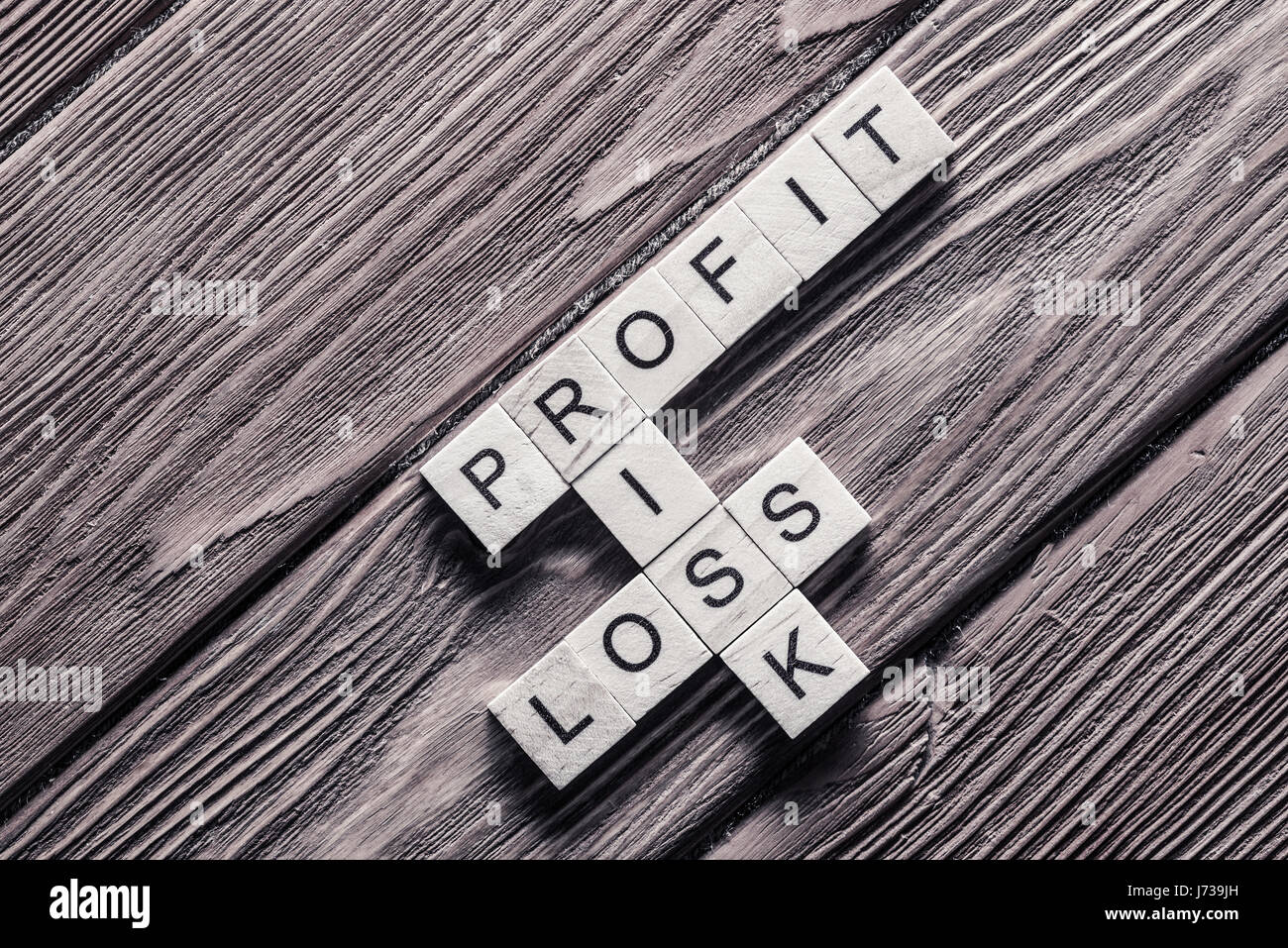 Profit loss and risk words on workplace collected of wooden cube Stock ...