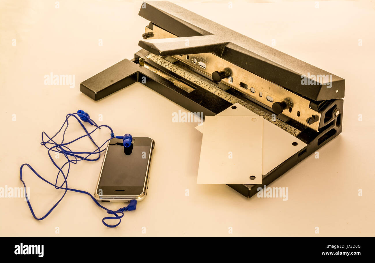 Hole puncher professional grade along the phone and paper Stock Photo ...