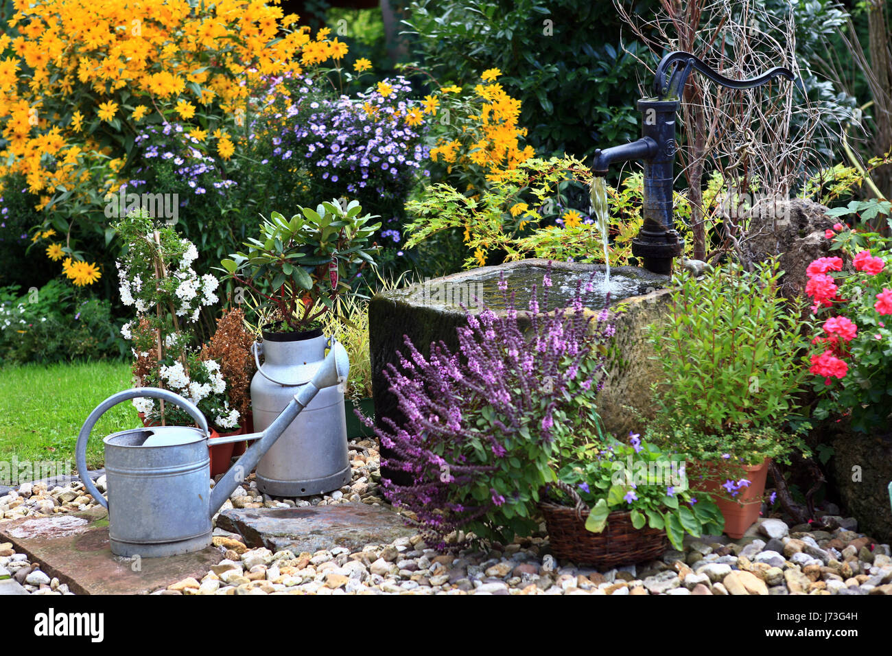 beam pump and trough in the garden Stock Photo - Alamy