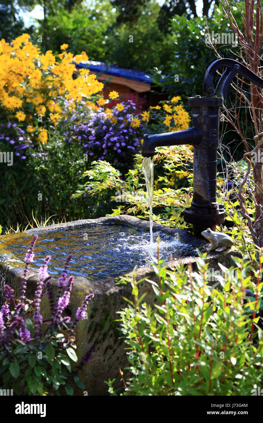 beam pump and trough in the garden Stock Photo - Alamy