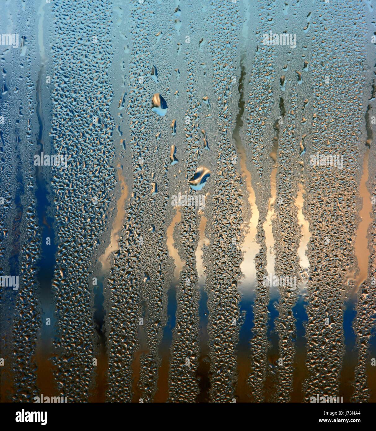 blue window porthole dormer window pane raindrop drop orange rain water ...