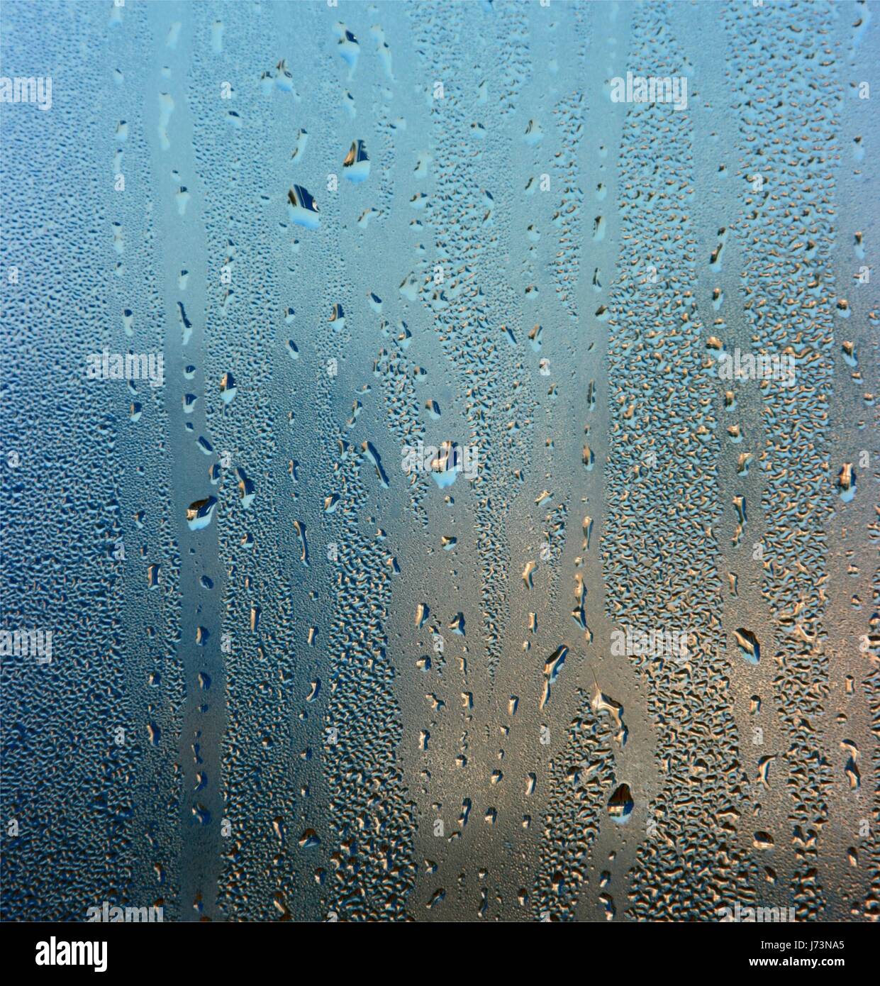 blue window porthole dormer window pane raindrop drop rain yellow water ...