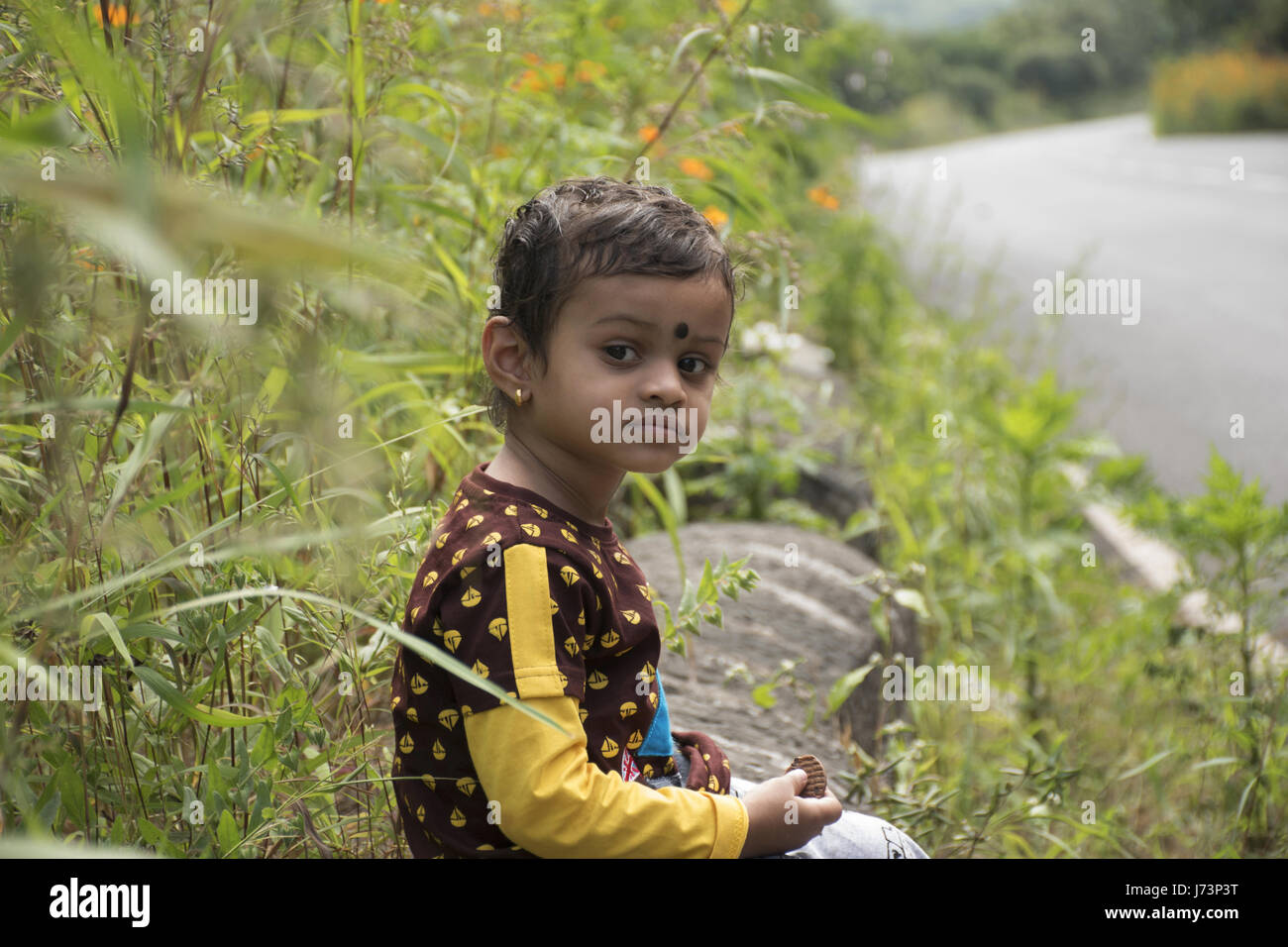 Small baby boy eating a biscuit Stock Photo - Alamy