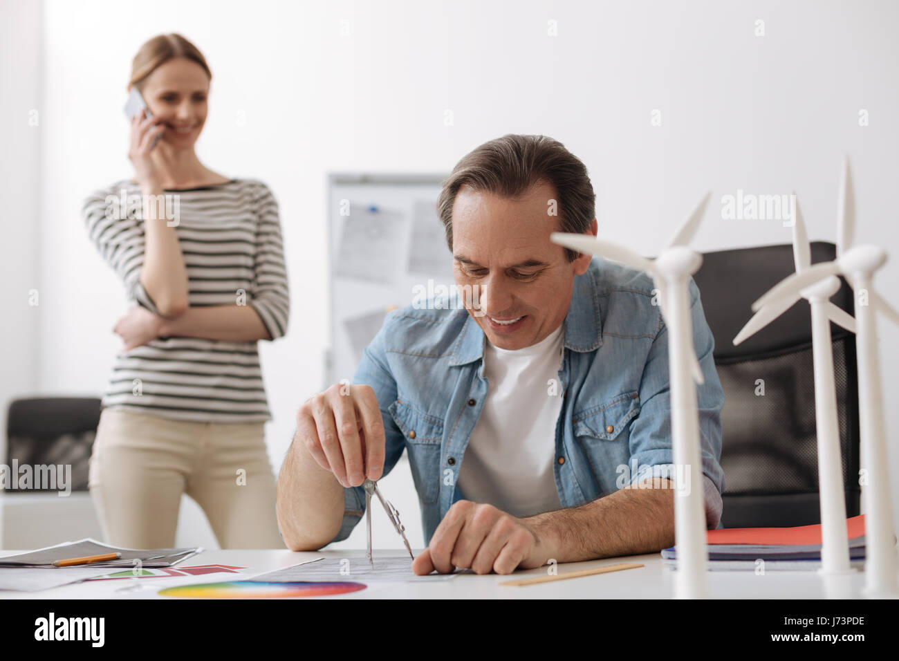 Positive senior engineer making a blueprint Stock Photo - Alamy