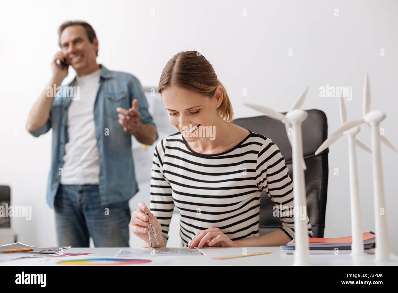 Cheerful female engineer making a drawing Stock Photo - Alamy
