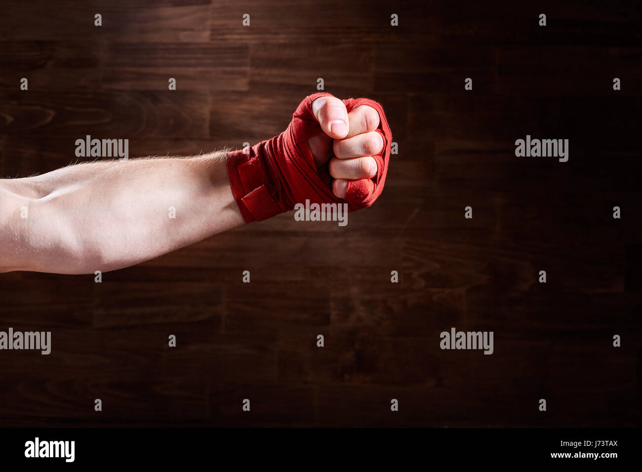 Boxer fist punch with red bandage on a wooden background Stock Photo ...