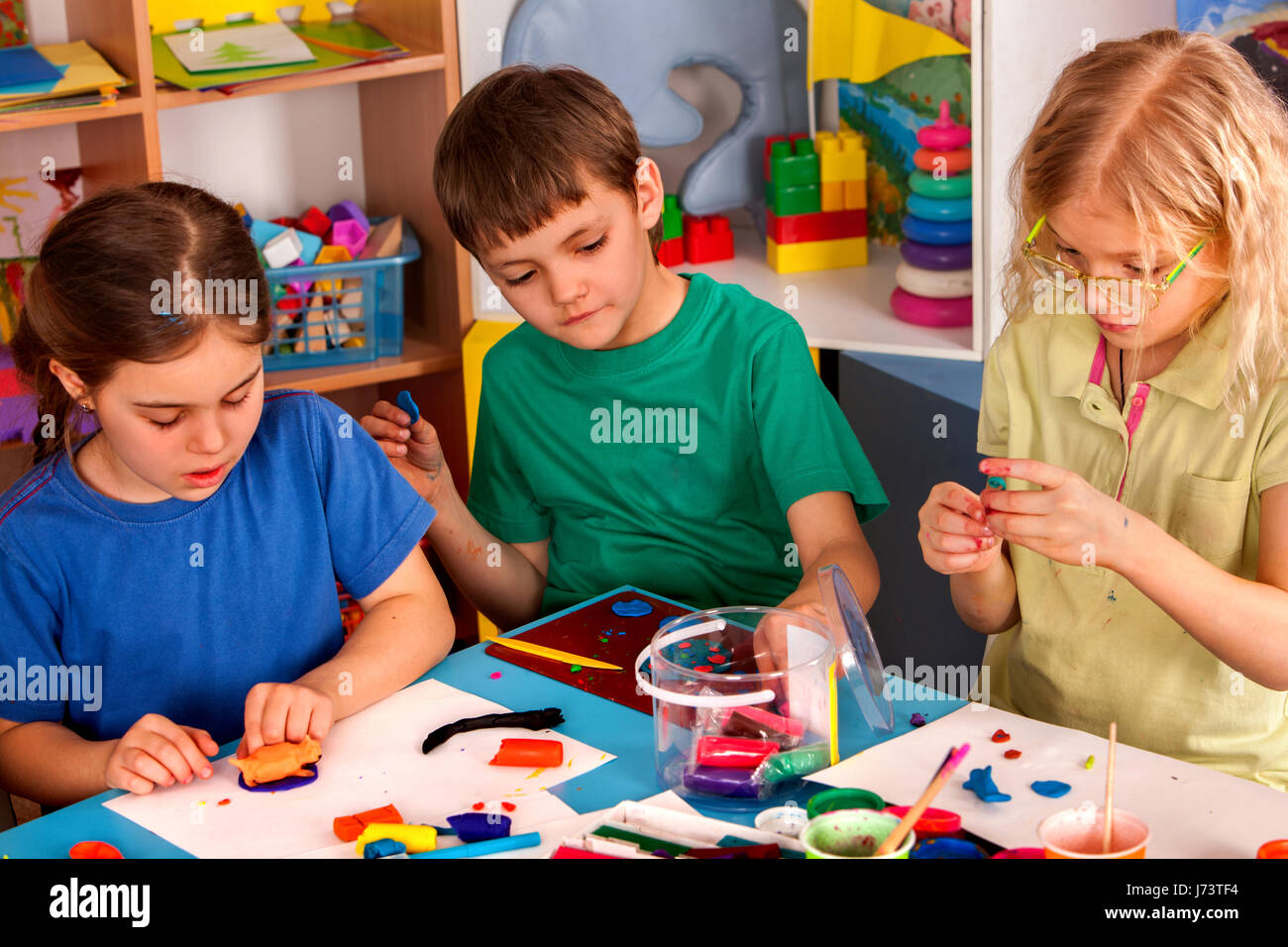 Plasticine modeling clay in children class. Teacher teaches in school ...