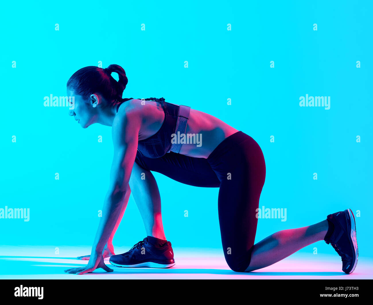 one mixed races woman runner running isolated on blue blackground Stock ...