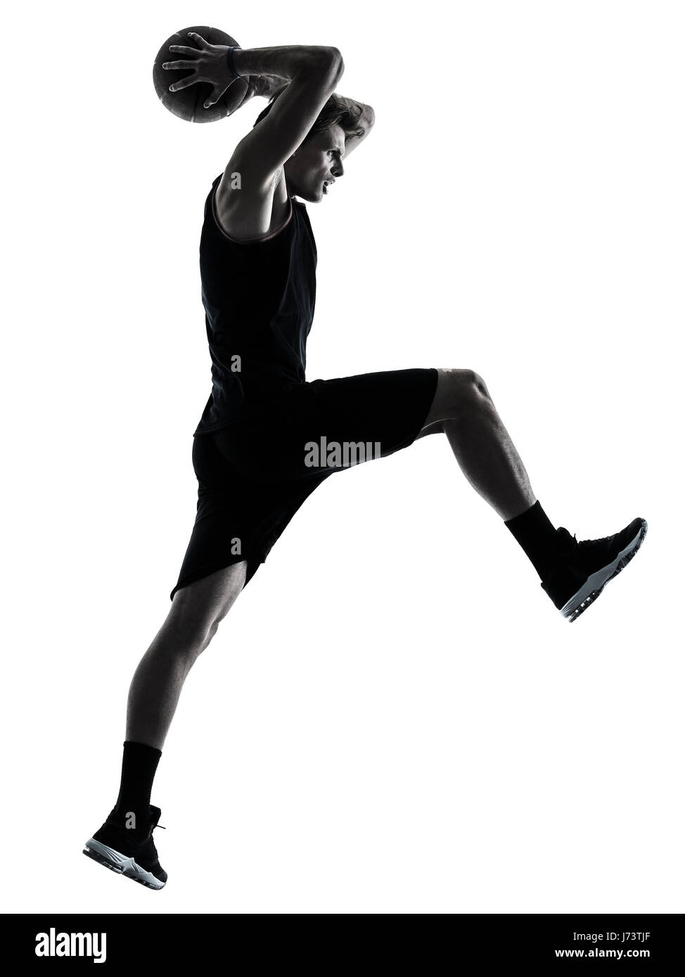 one caucasian basketball player man isolated in silhouette shadow on ...