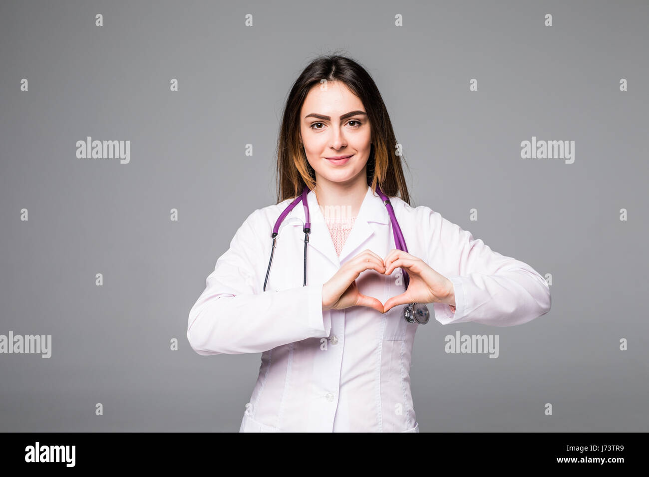 Doctor putting their hands in the shape of heart isolated on white ...