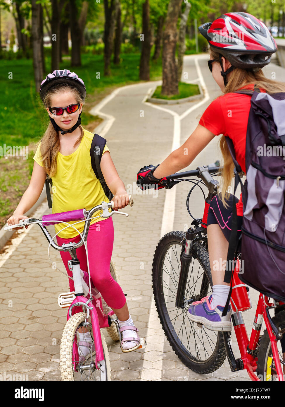 Bicycle path sign with children. Girls wearing helmet with rucksack ...