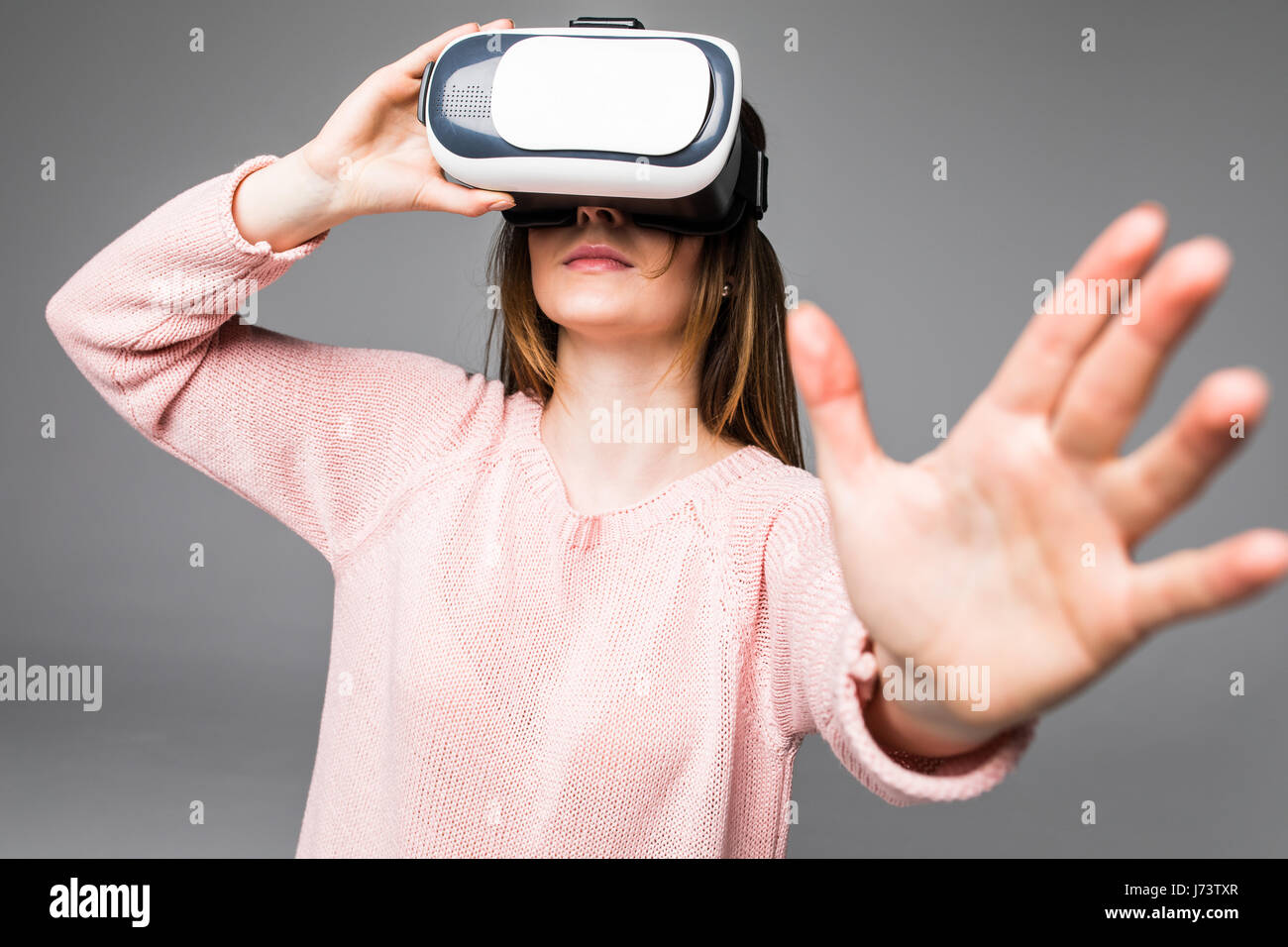 young attractive woman wearing headset VR virtual reality vision ...