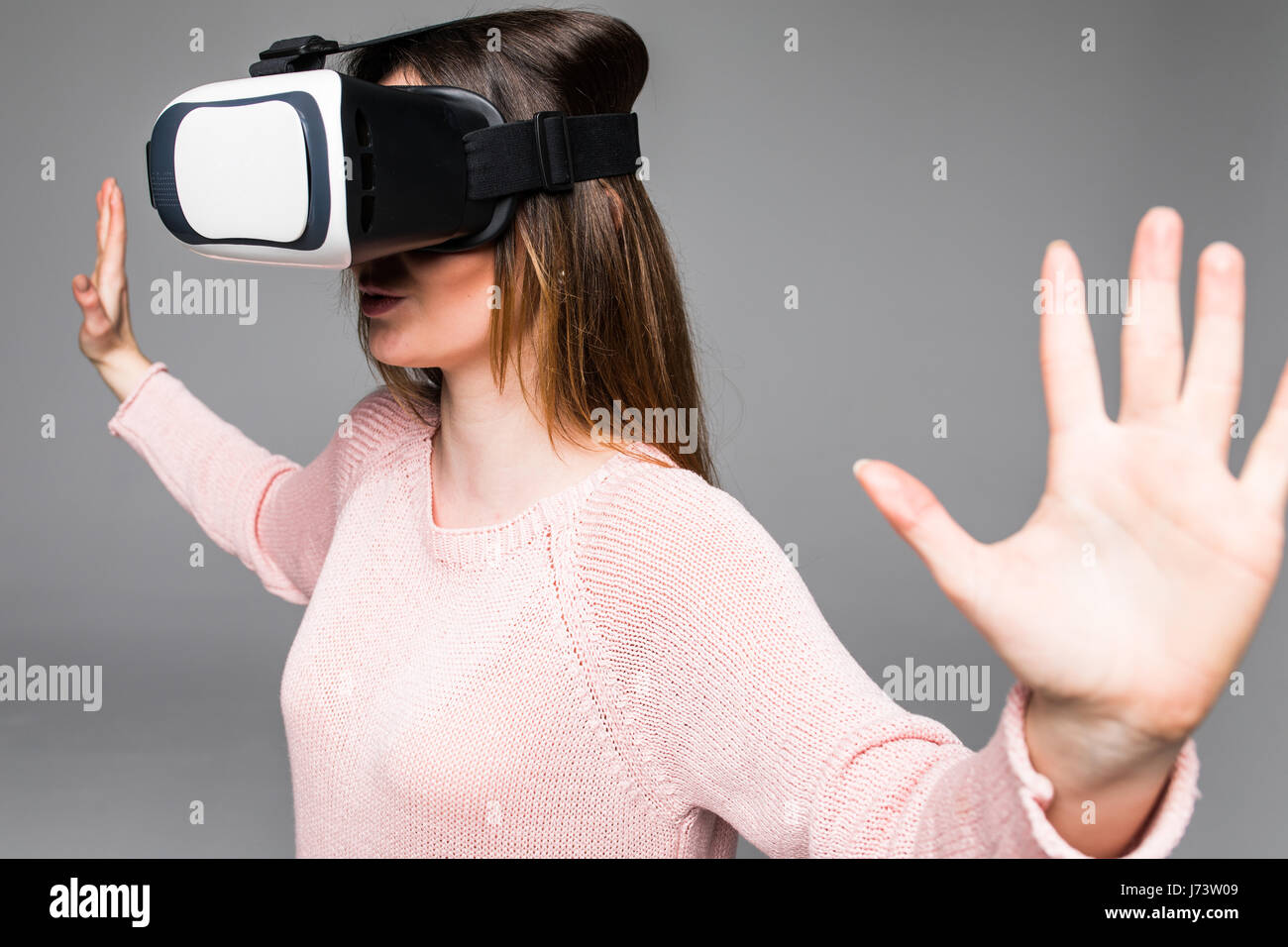 attractive young woman looking through virtual reality headset, indoor ...