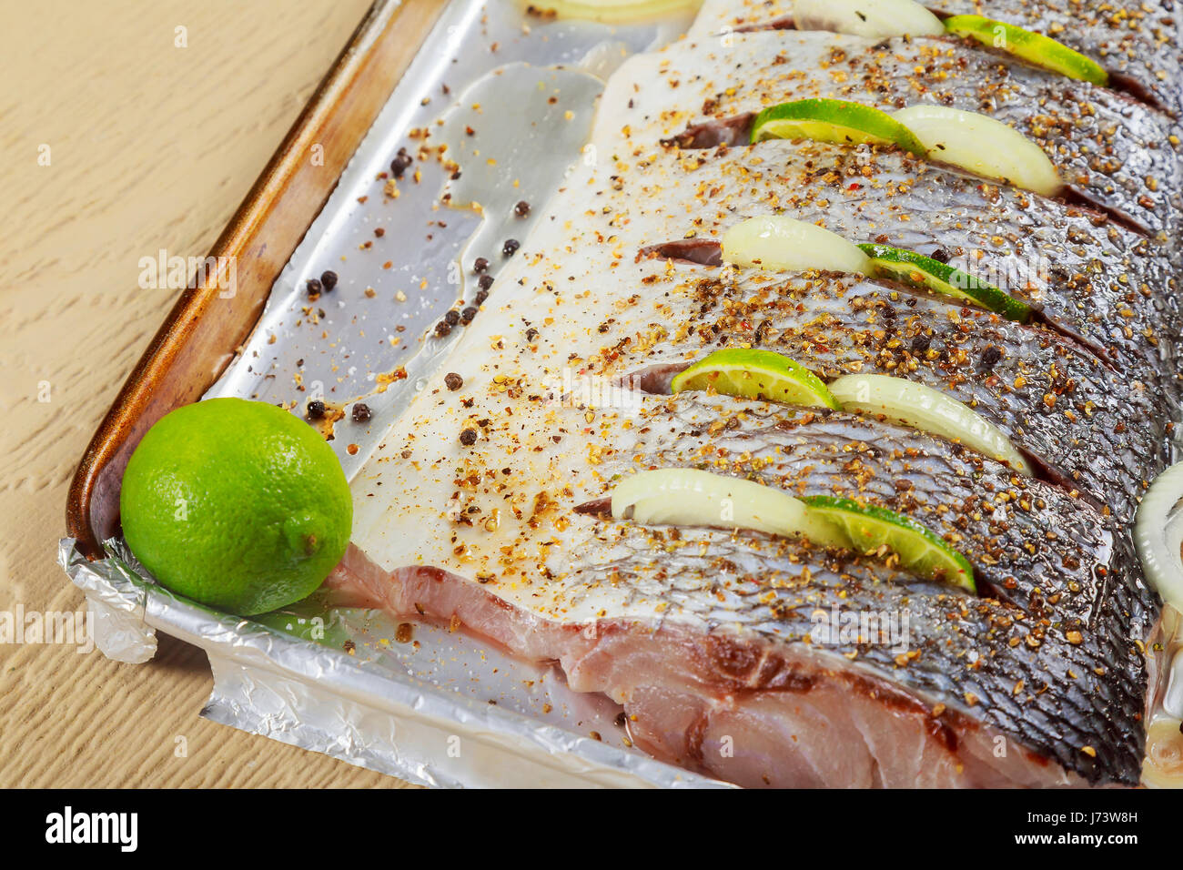 Marinated fried fish fry with spices n lemon filets in oil with lemon ...