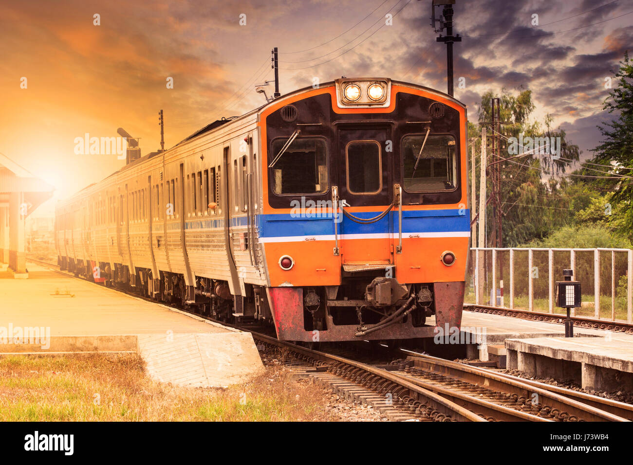 diesel engine trains on track ways station against beautiful dusky sky ...