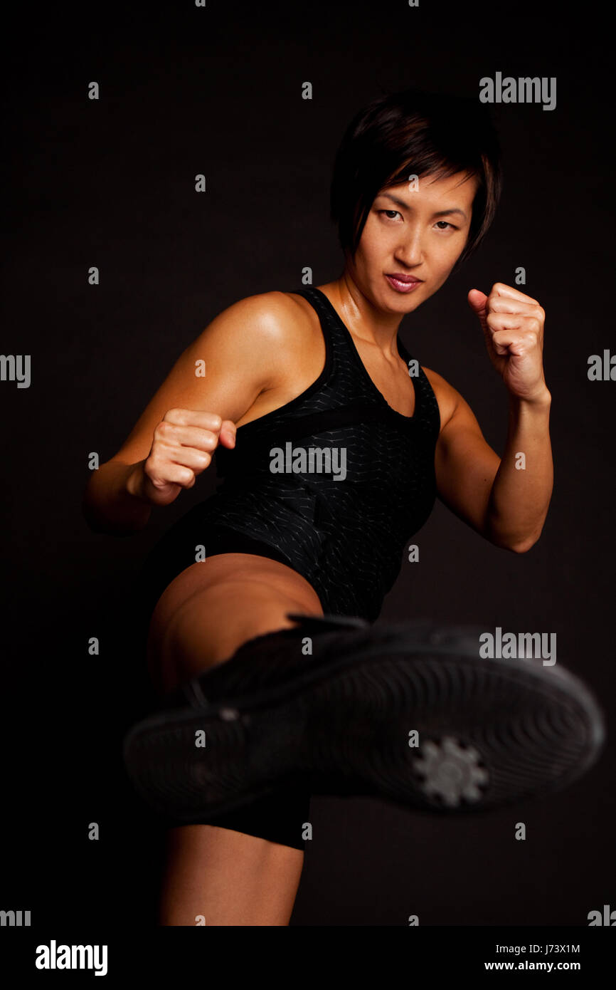 Portrait of woman practicing self defense Stock Photo - Alamy