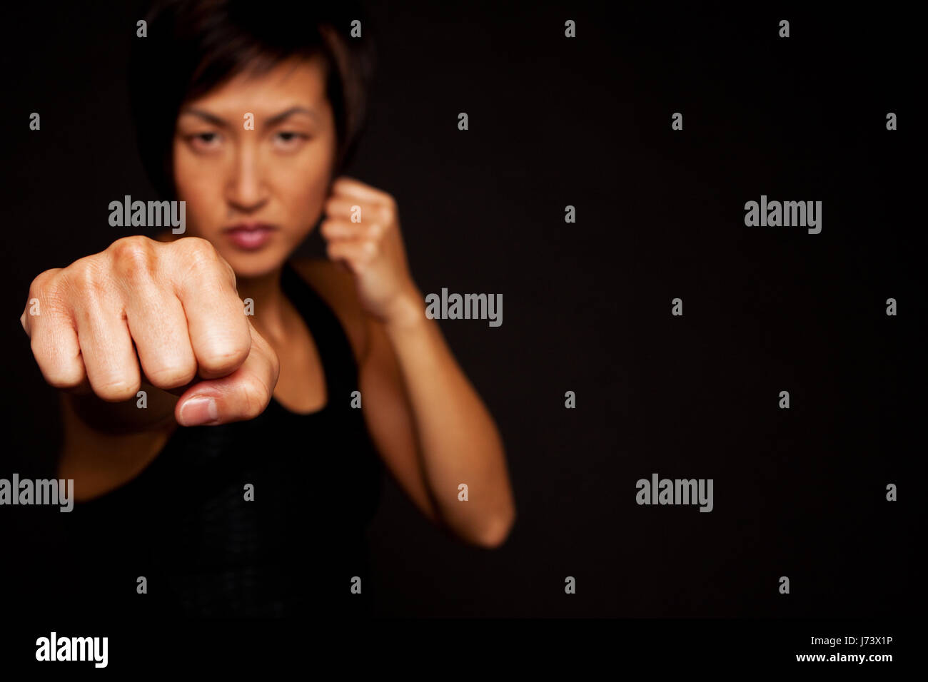 Portrait of woman practicing self defense Stock Photo - Alamy