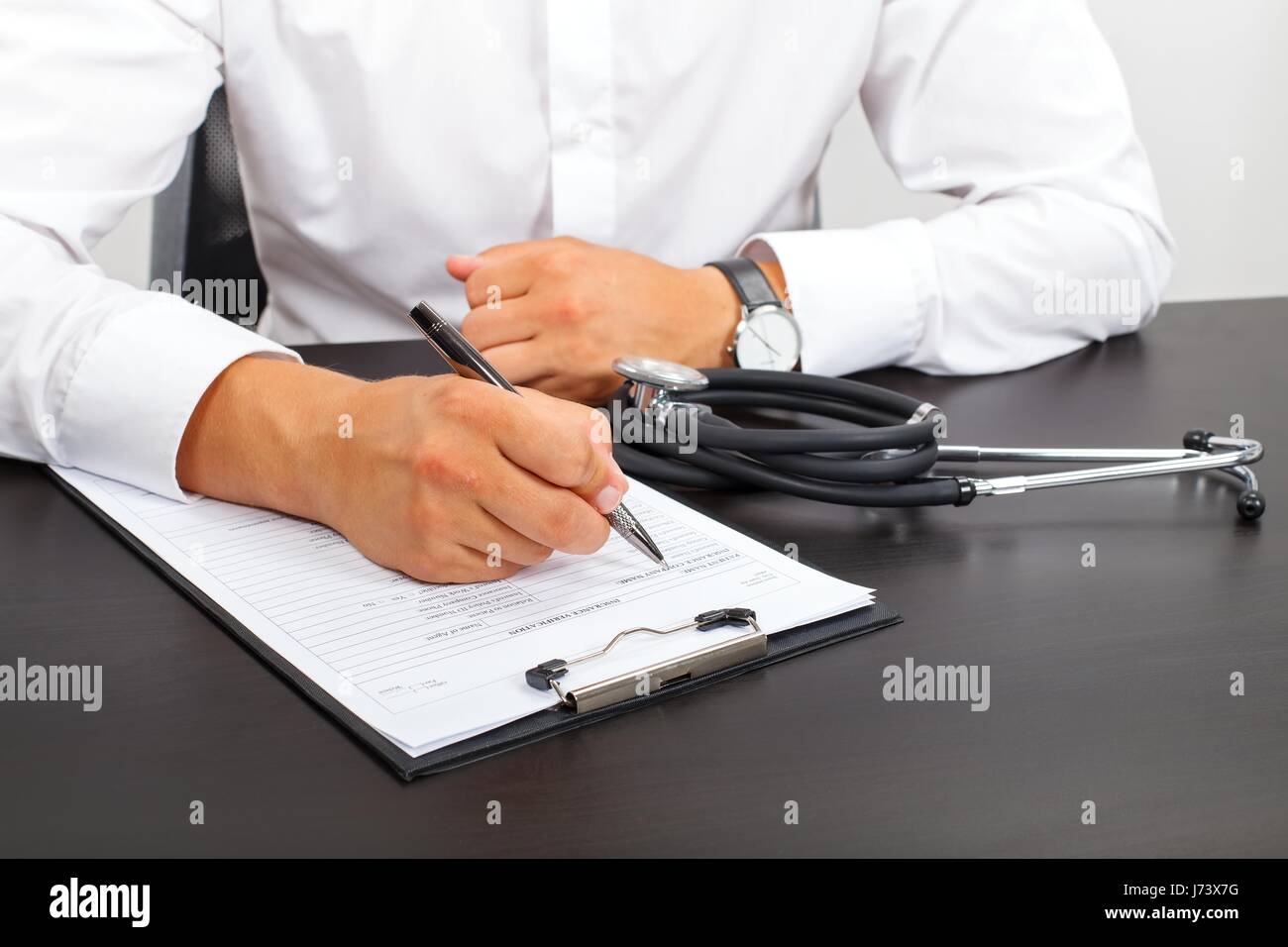 Picture of a doctor's hand signing on the medical report Stock Photo ...