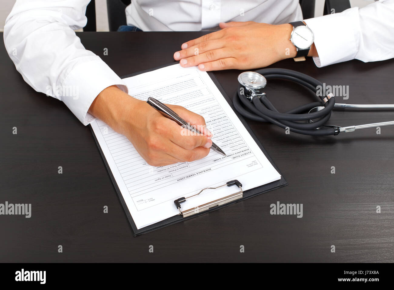 Picture of a doctor's hand signing on the medical report Stock Photo ...