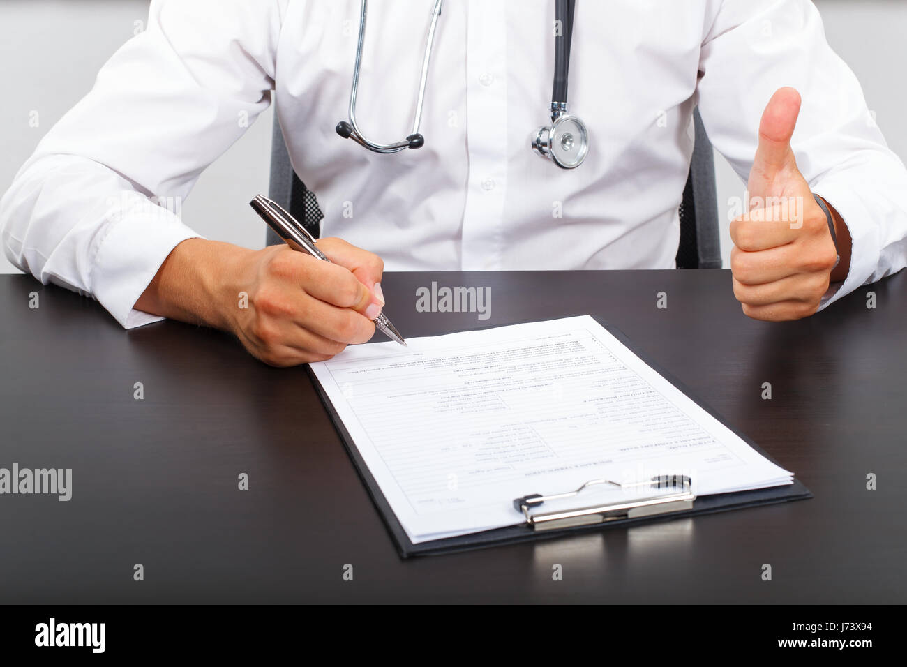 Picture of a doctor's hand signing on the medical report Stock Photo ...