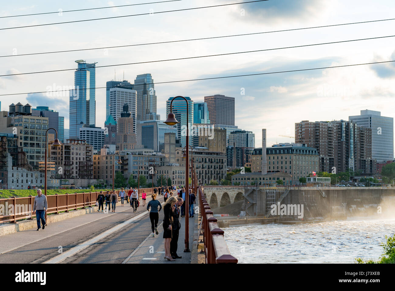 People enjoy a walking and biking path at the Stone Arch Bridge in ...