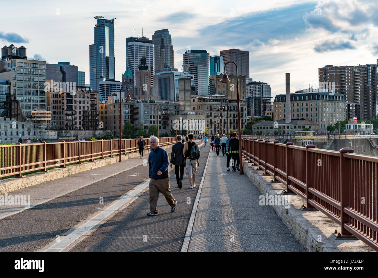 People enjoy a walking and biking path at the Stone Arch Bridge in ...