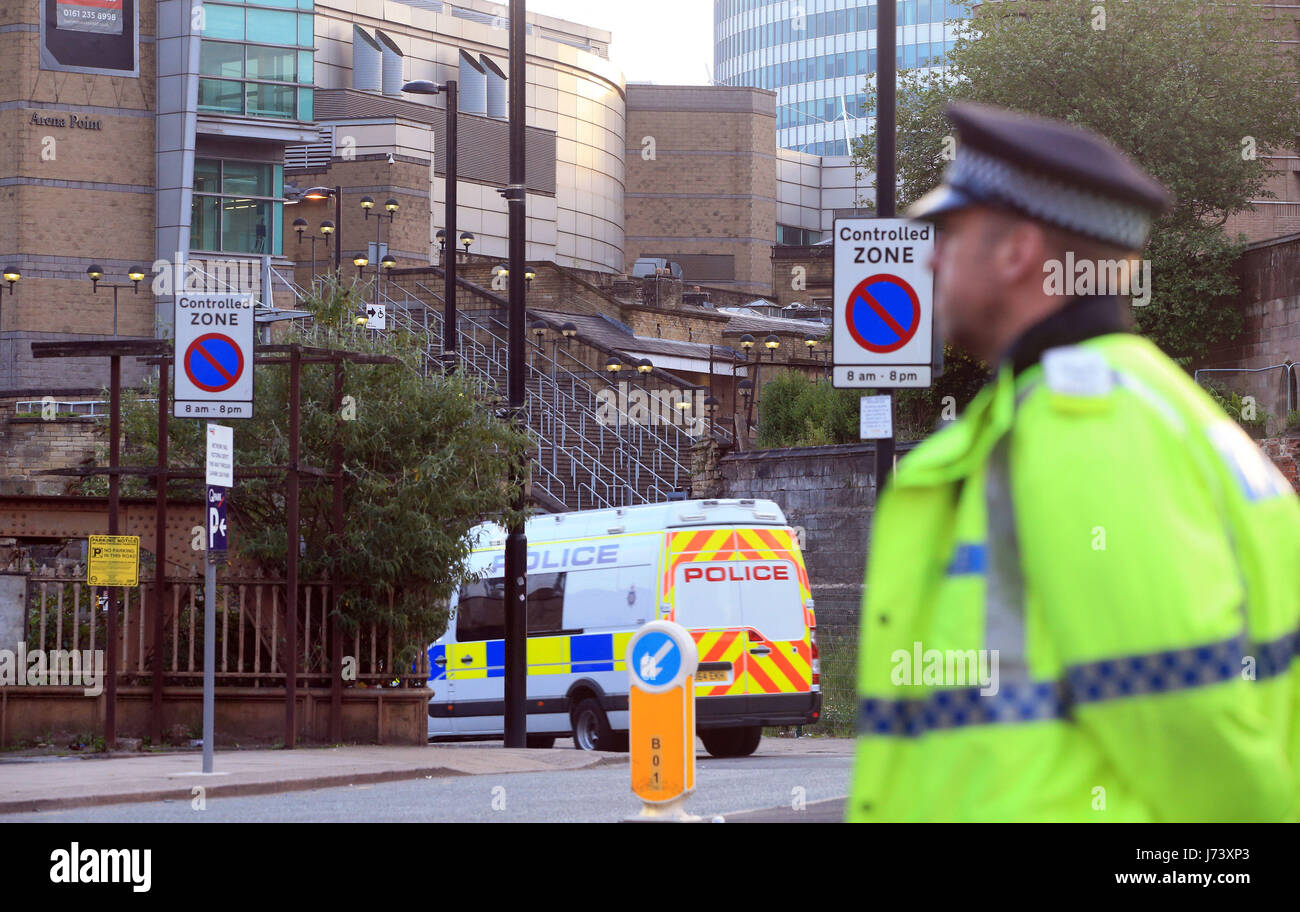 A police officer stands near the Manchester Arena (steps in background ...
