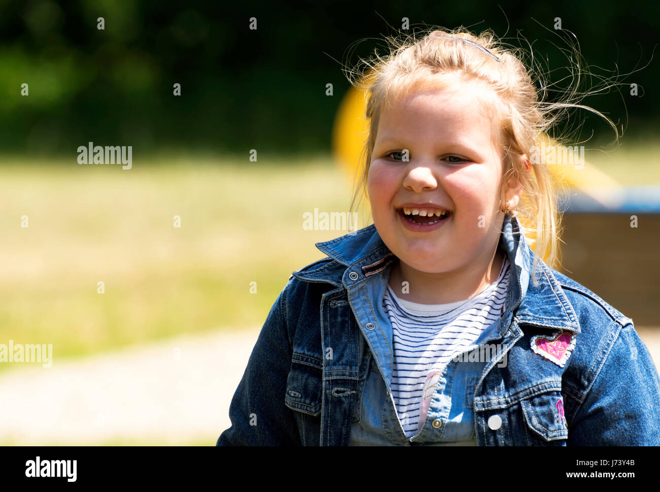 Happy little girl at playground Stock Photo - Alamy