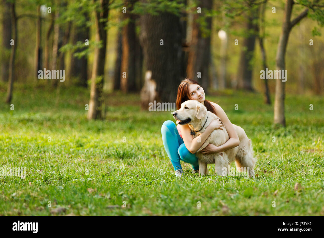 Owner with labrador in park Stock Photo - Alamy
