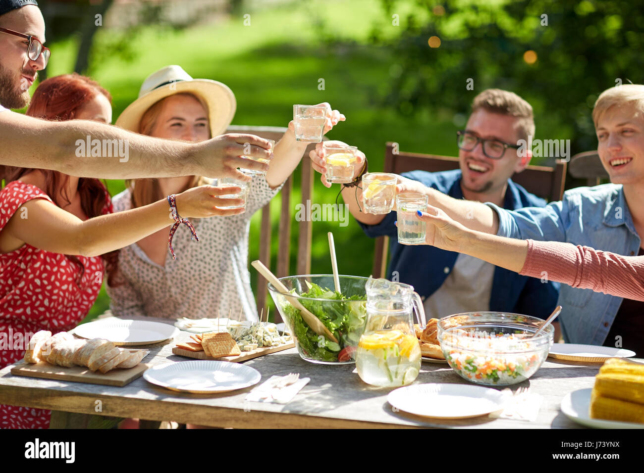 happy friends with drinks at summer garden party Stock Photo - Alamy