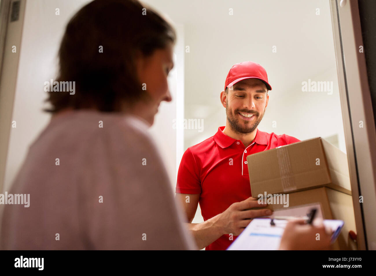 Man signing delivery boxes hi-res stock photography and images - Alamy