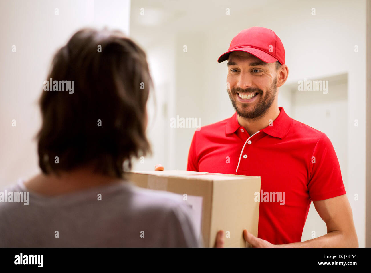 happy delivery man giving parcel box to customer Stock Photo - Alamy