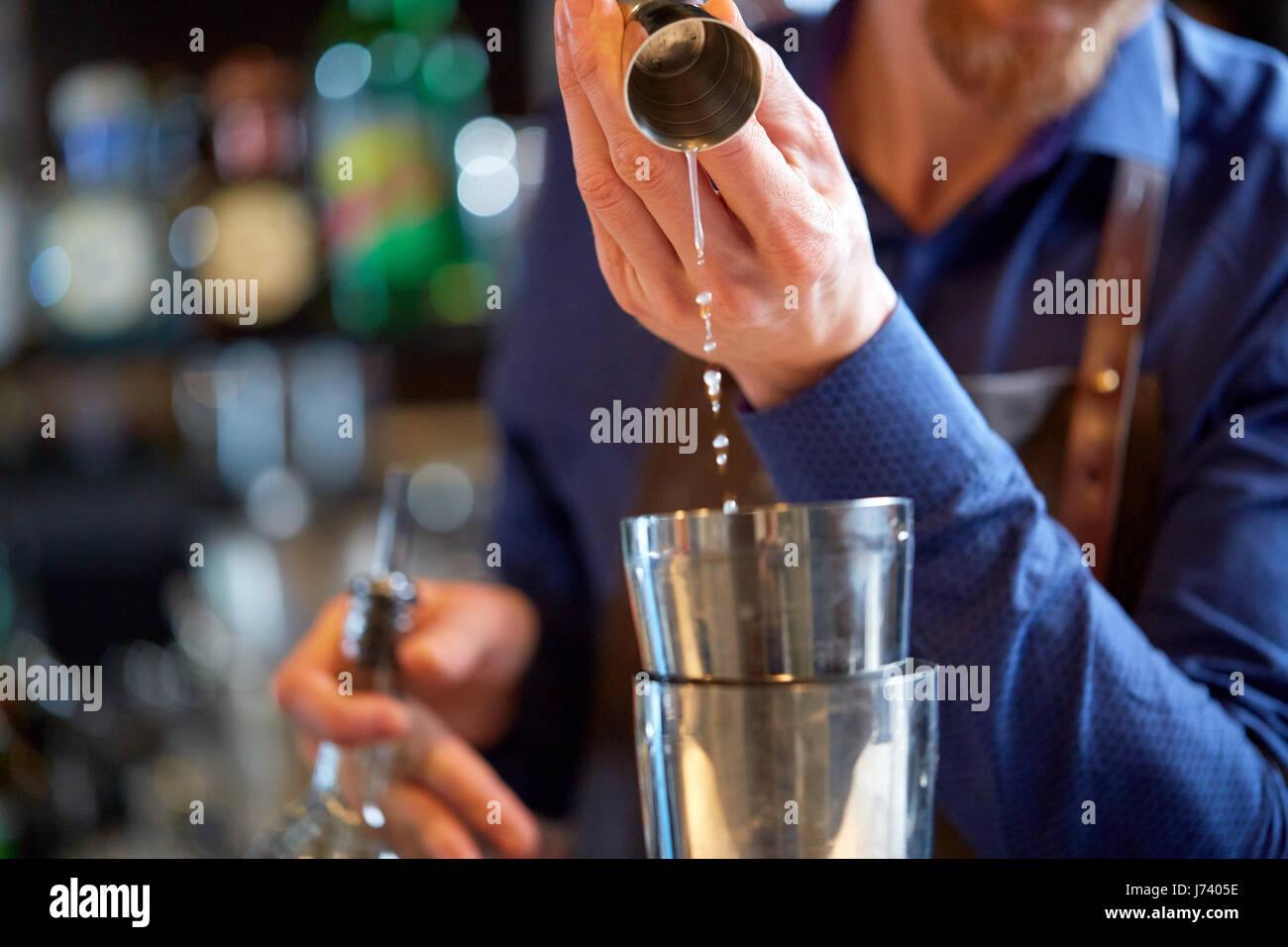 bartender with shaker preparing cocktail at bar Stock Photo - Alamy