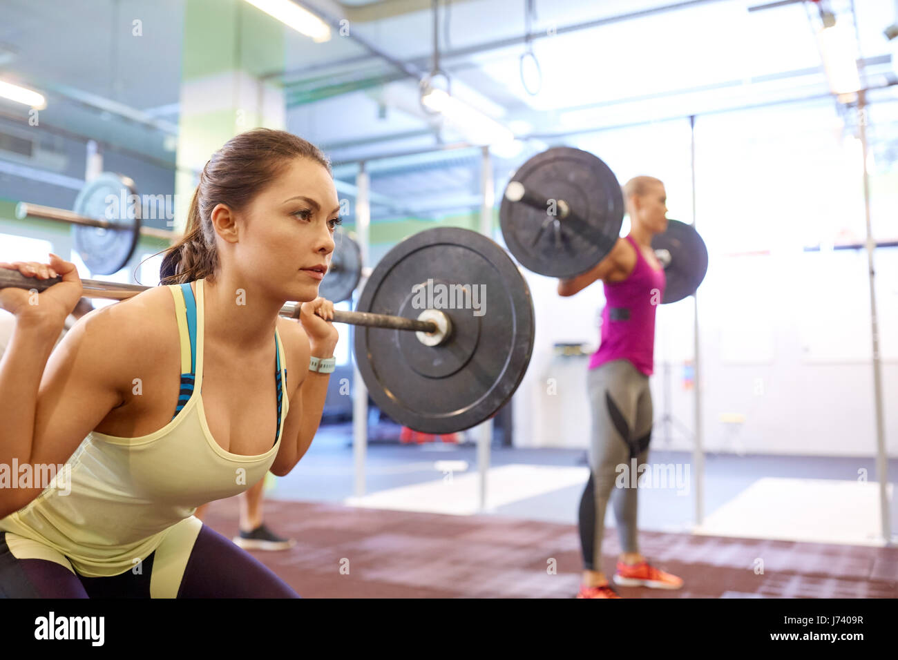 group of people training with barbells in gym Stock Photo - Alamy