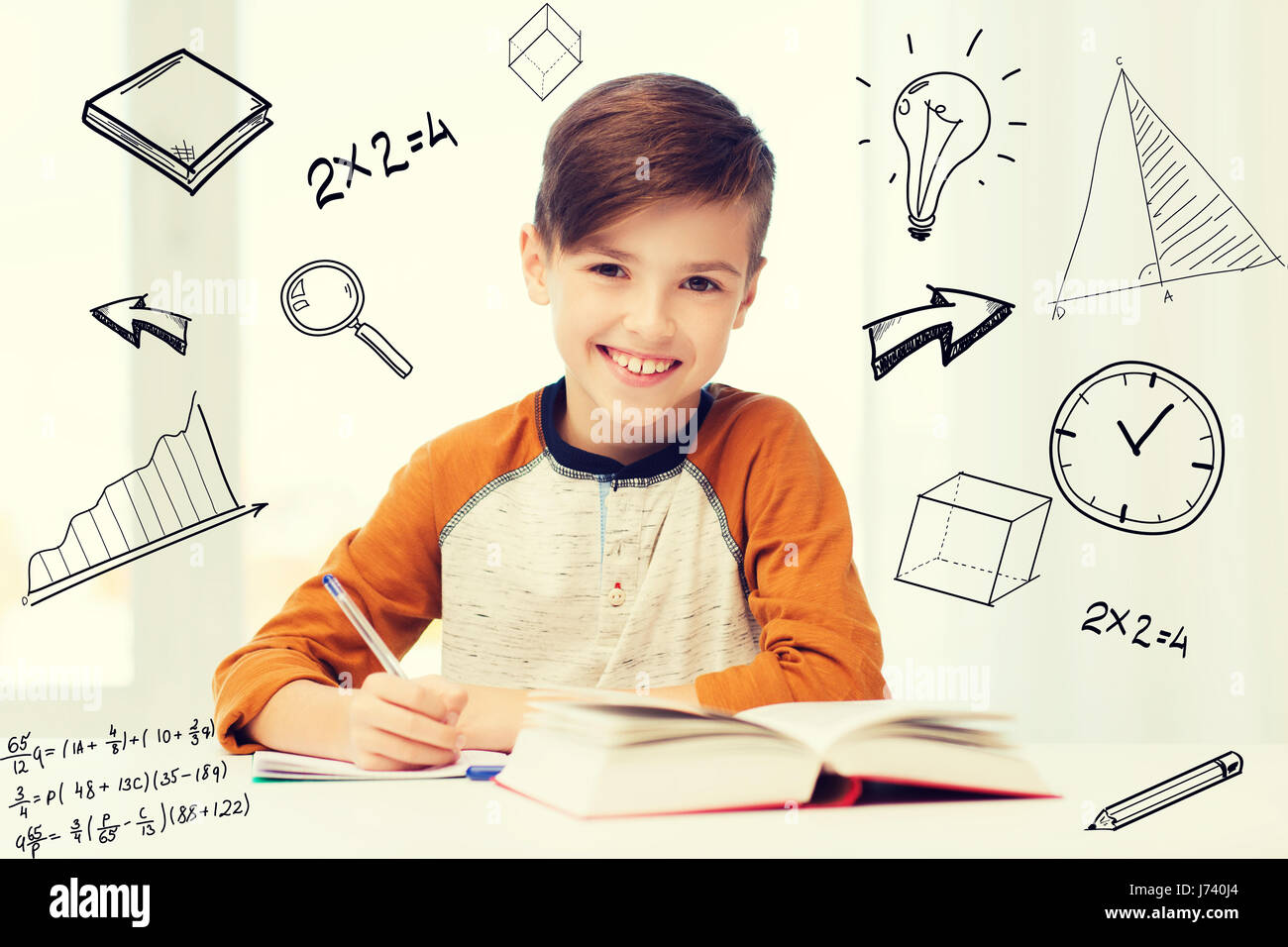 smiling student boy writing to notebook at home Stock Photo - Alamy