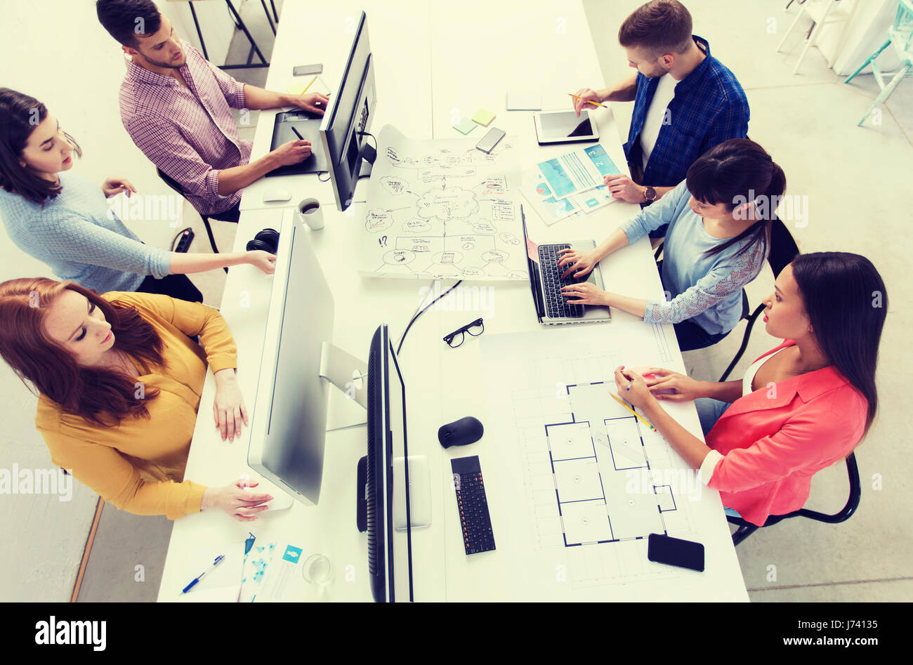 creative team with computers, blueprint at office Stock Photo - Alamy