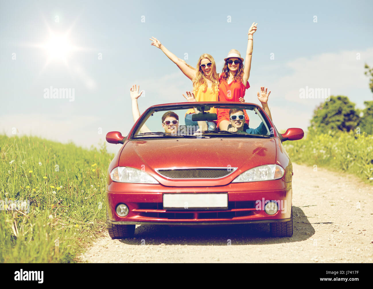 happy friends driving in cabriolet car at country Stock Photo - Alamy